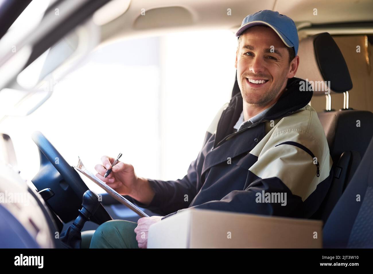 He never misses a delivery deadline. Portrait of a delivery man writing ...