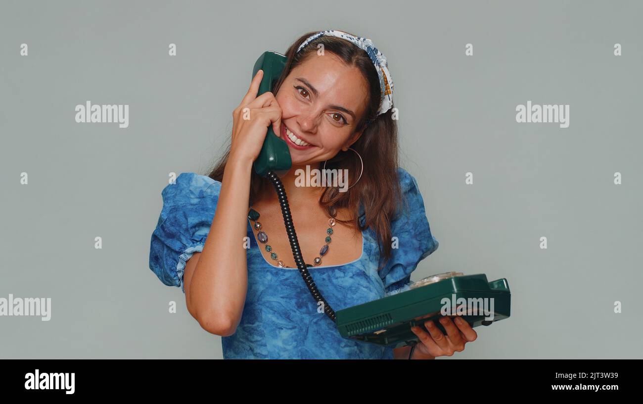 Hey you, call me back. Pretty young woman in princess dress talking on ...