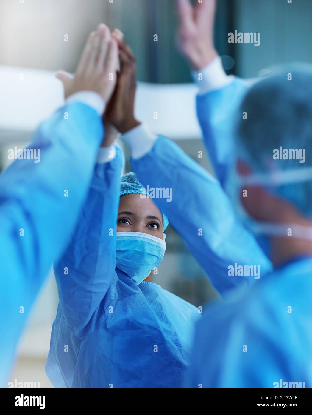 Wellness for the win. a team of surgeons giving each other a high five ...