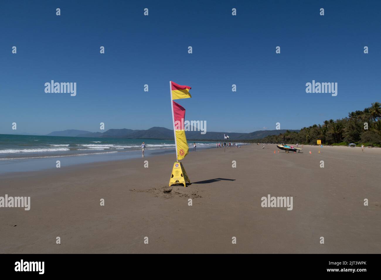 Australian lifeguard signs and red and yellow flags at Four Mile Beach ...