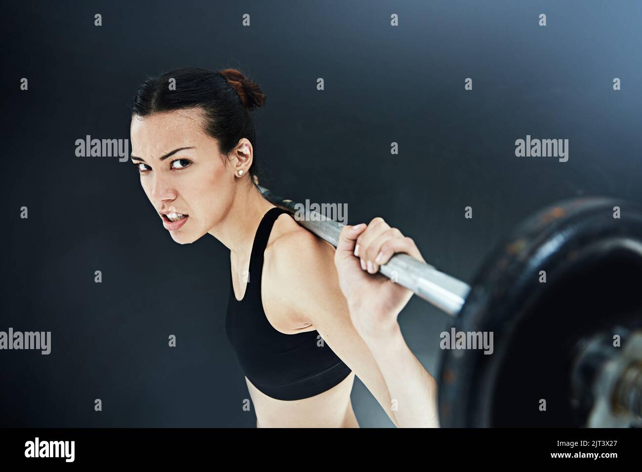 I will prove no goal is out of reach. a young woman lifting weights ...