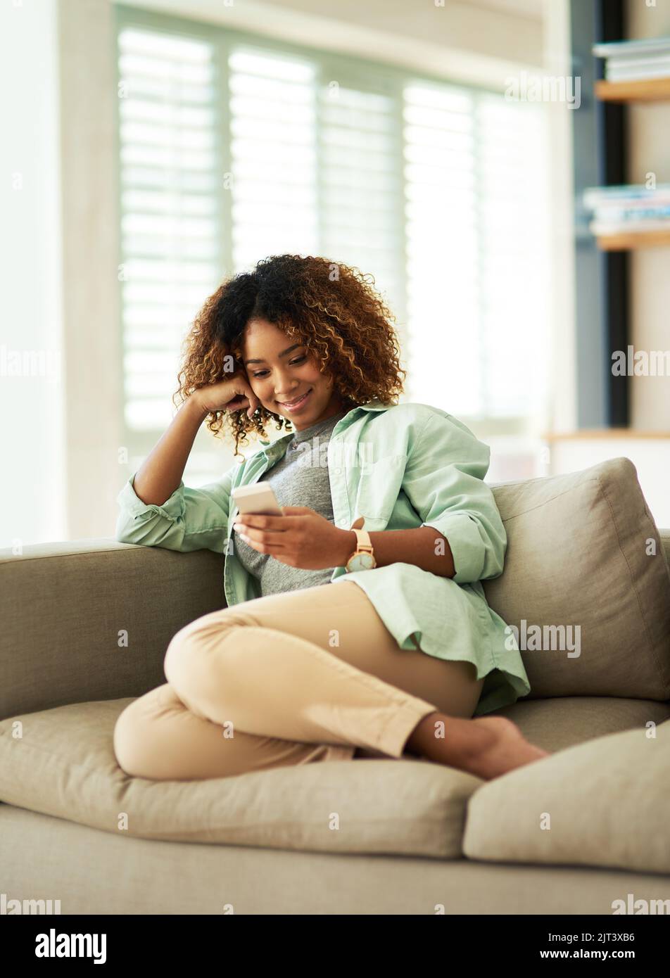 Texting her friends. An attractive young woman using her cellphone ...