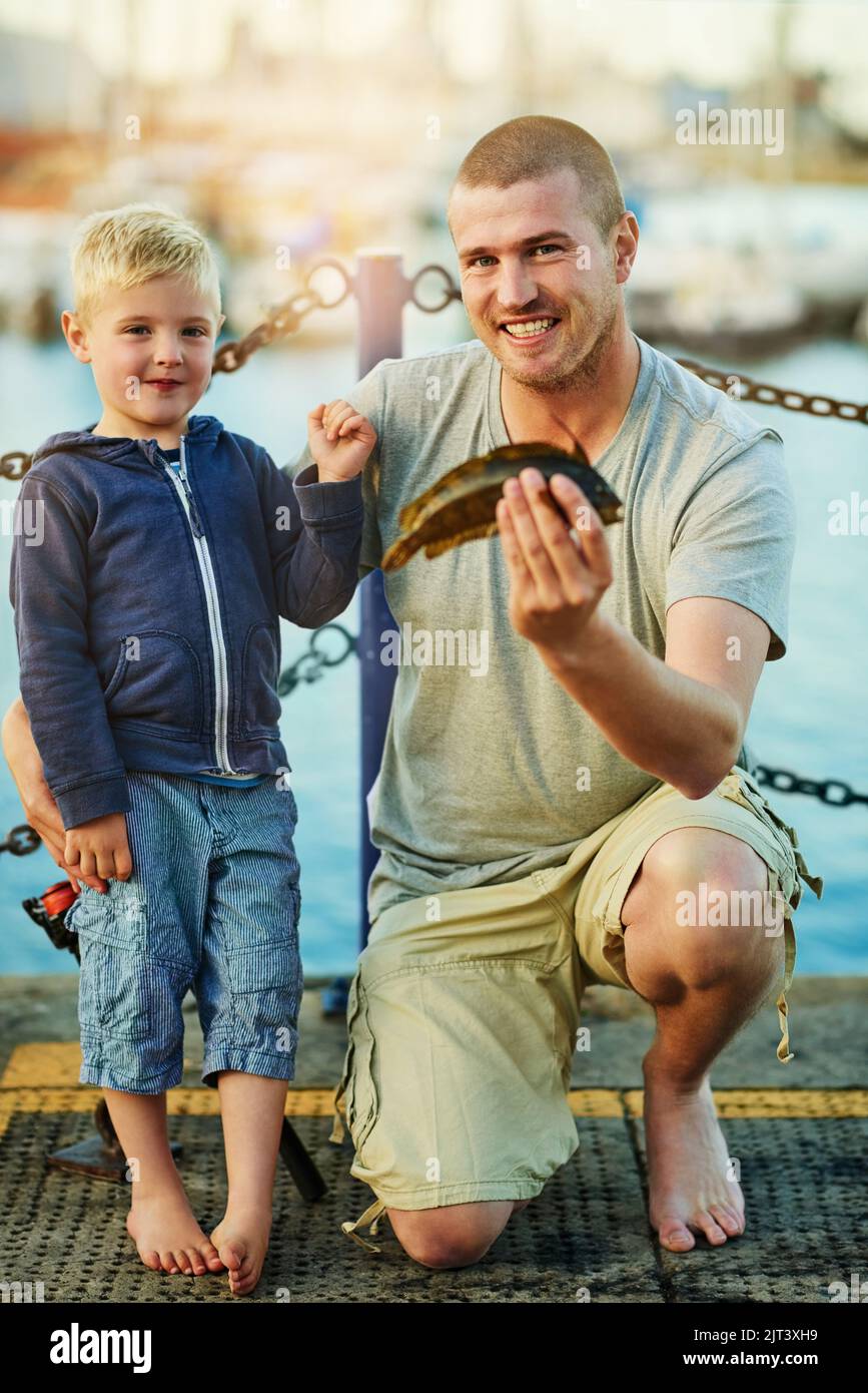 Proud of his boys first catch. Portrait of a father and his little boy ...