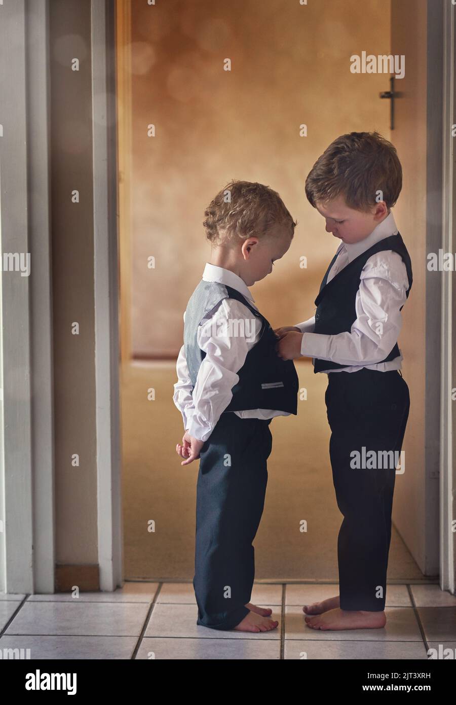Looking out for his little brother. a sweet little boy helping his ...