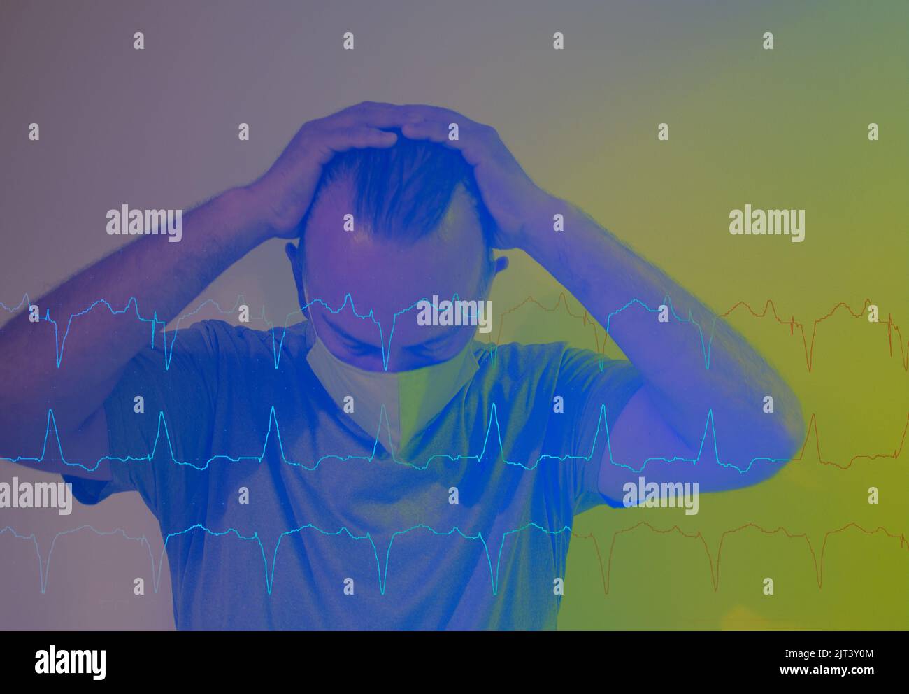 Middle-aged white male holding his head with both hands behind an EKG ...