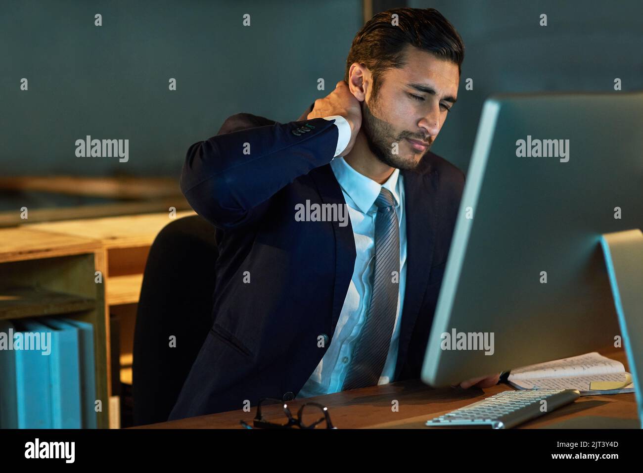 The stress just keeps piling up. a young businessman experiencing neck ...