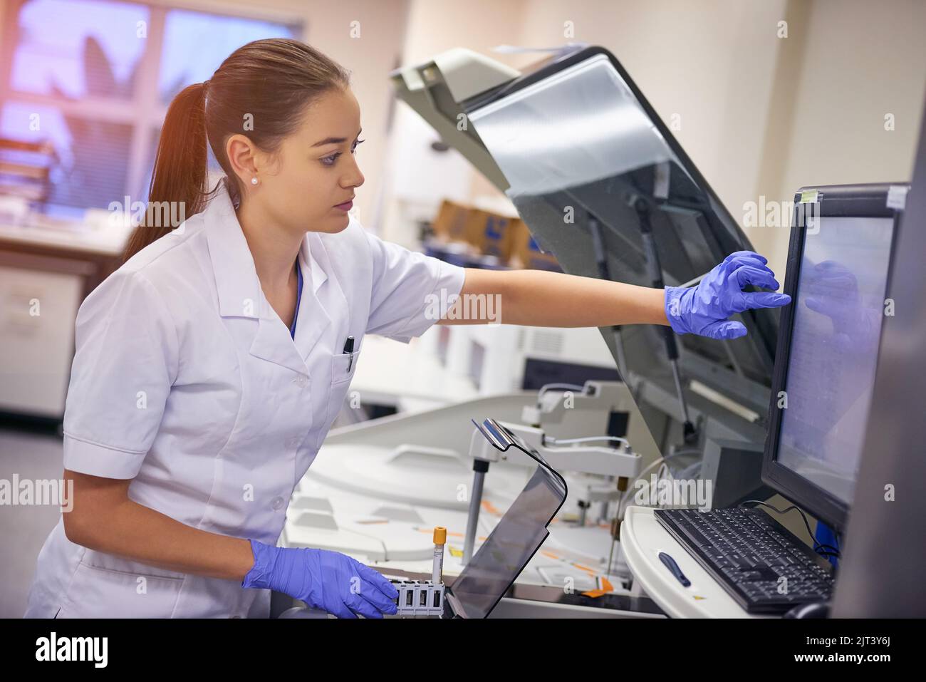 The cure is just a tap away. a young scientist using a computer to ...
