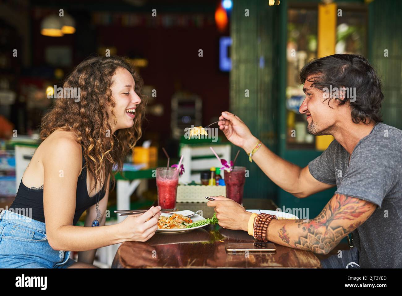 Try this, its delicious. two young tourists enjoying lunch together in ...
