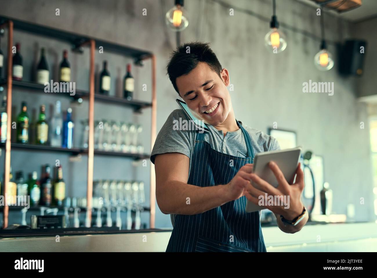 Sure, we can arrange that for you. a young man taking orders via ...