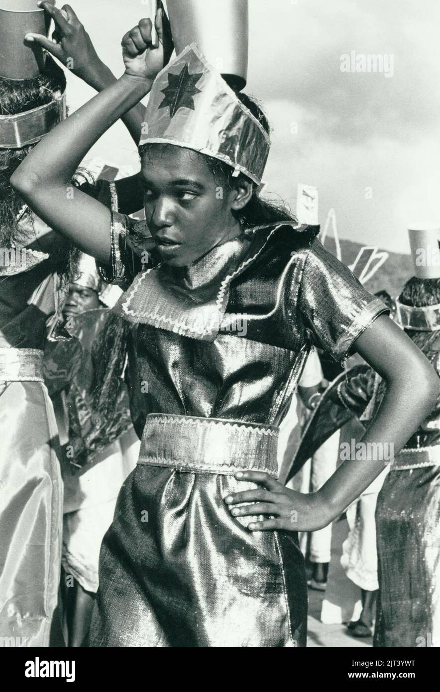 A young woman wearing a shiny costume and crown during carnival ...