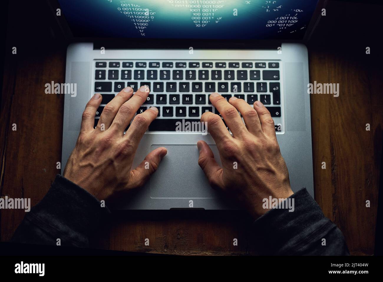 Coding all night long. High angle shot of an unidentifiable man using a ...