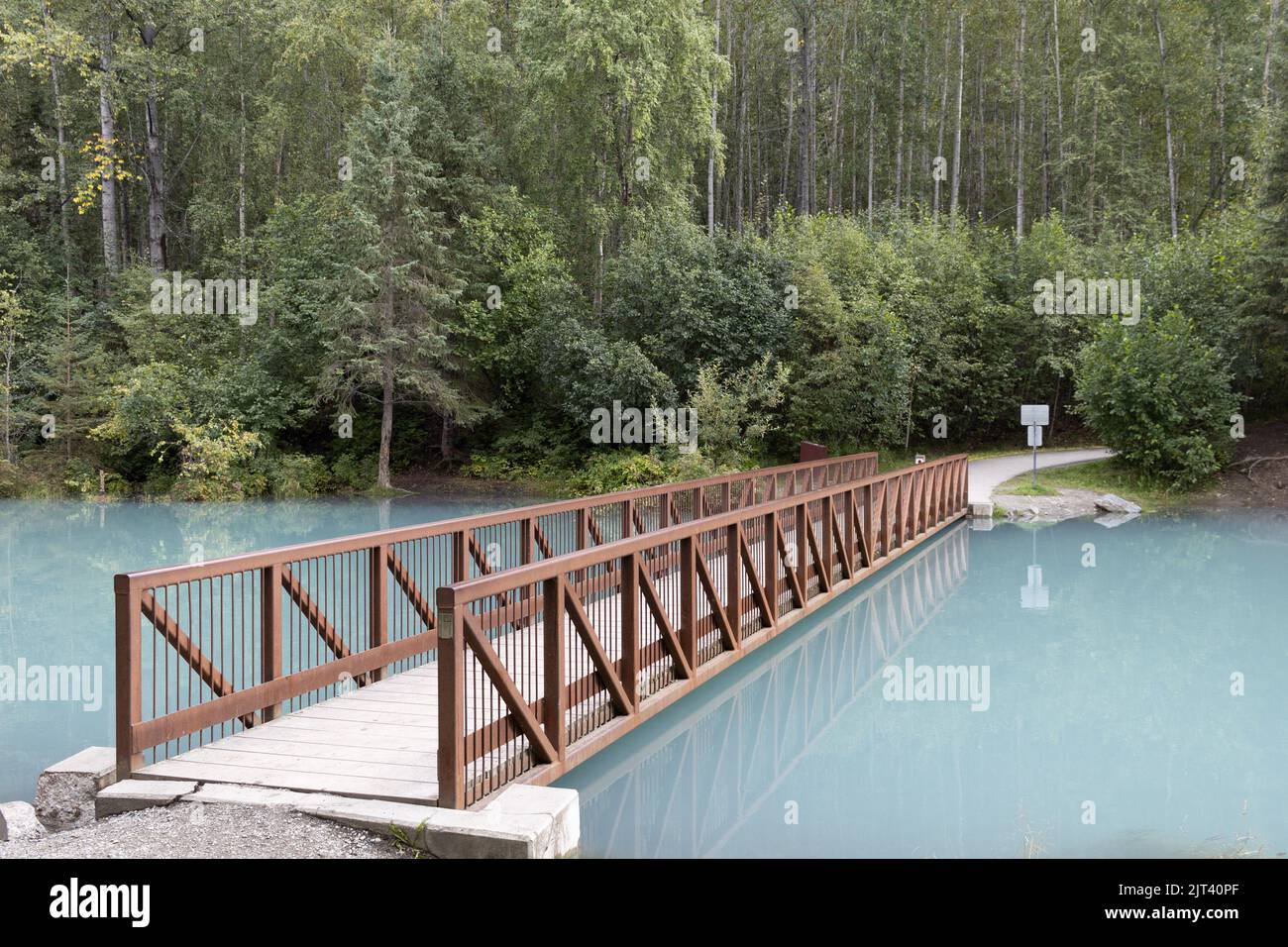 A wooden bridge over blue creek in Alaska Stock Photo - Alamy