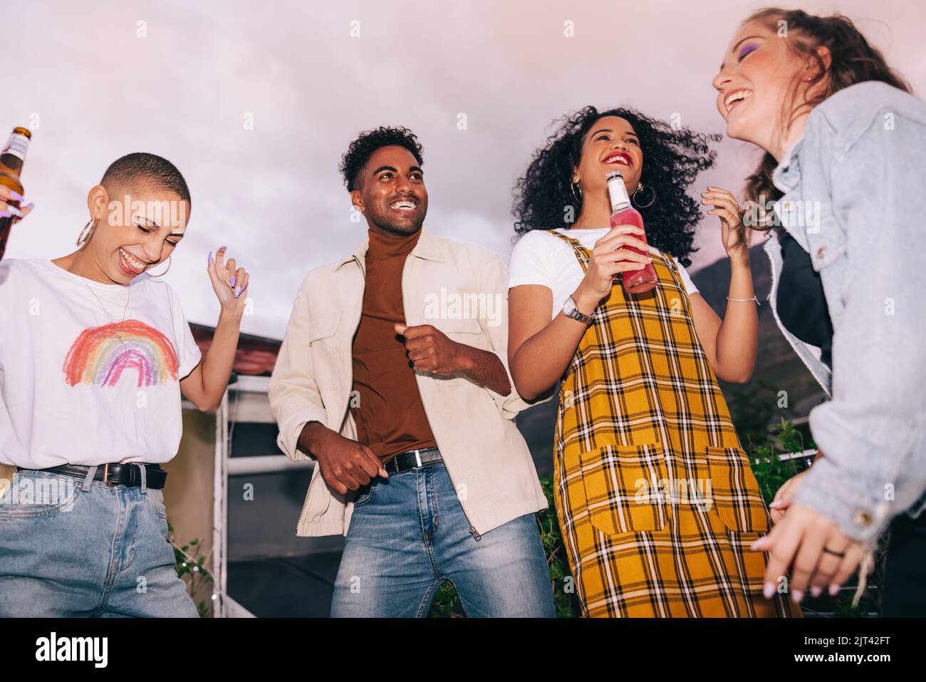 Friends dancing during a rooftop party. Group of happy generation z ...