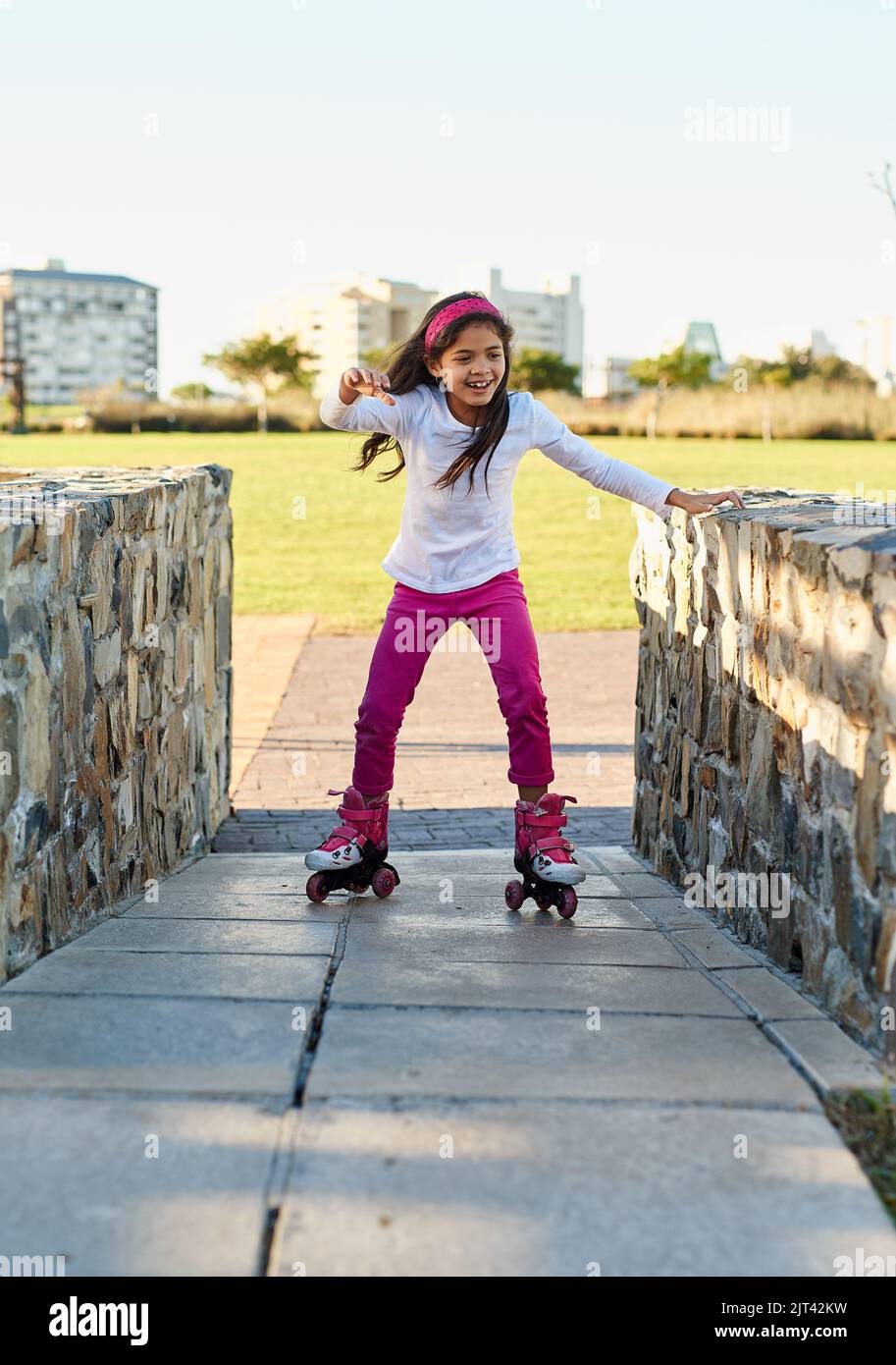 This is way more fun than I thought. a young girl roller skating at the ...