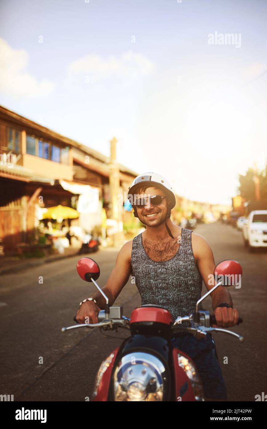 Scooter riding is, above all, great fun. a young man taking a drive ...