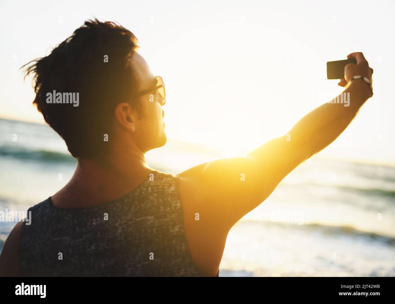 Go somewhere you can be your selfie. a young man taking a selfie at the ...