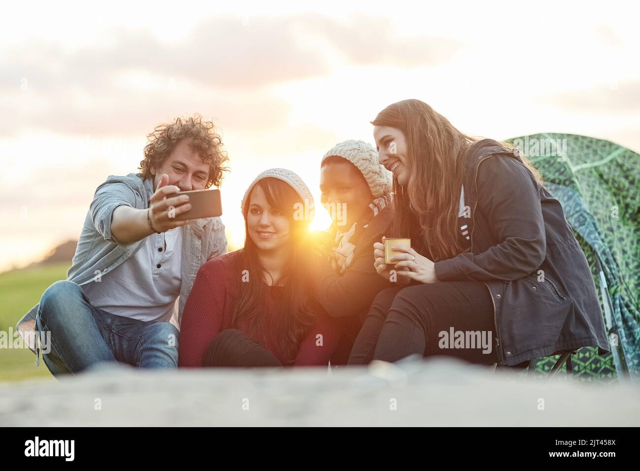 Time for a camp selfie. a group of friends taking a selfie together ...