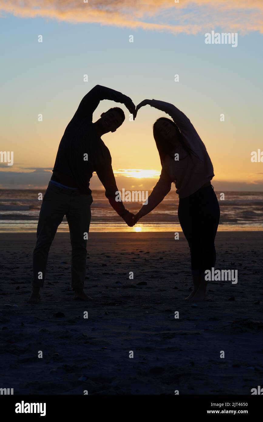 Life is nothing without love. Silhouette shot of a young couple on the ...