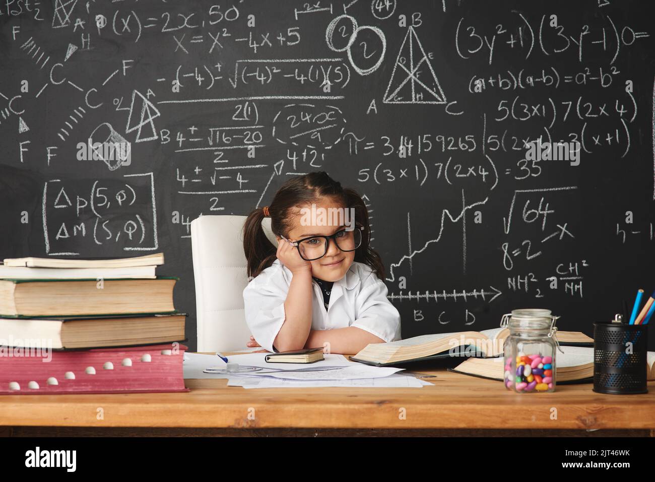 Every child is born a genius. an academically gifted young girl working ...