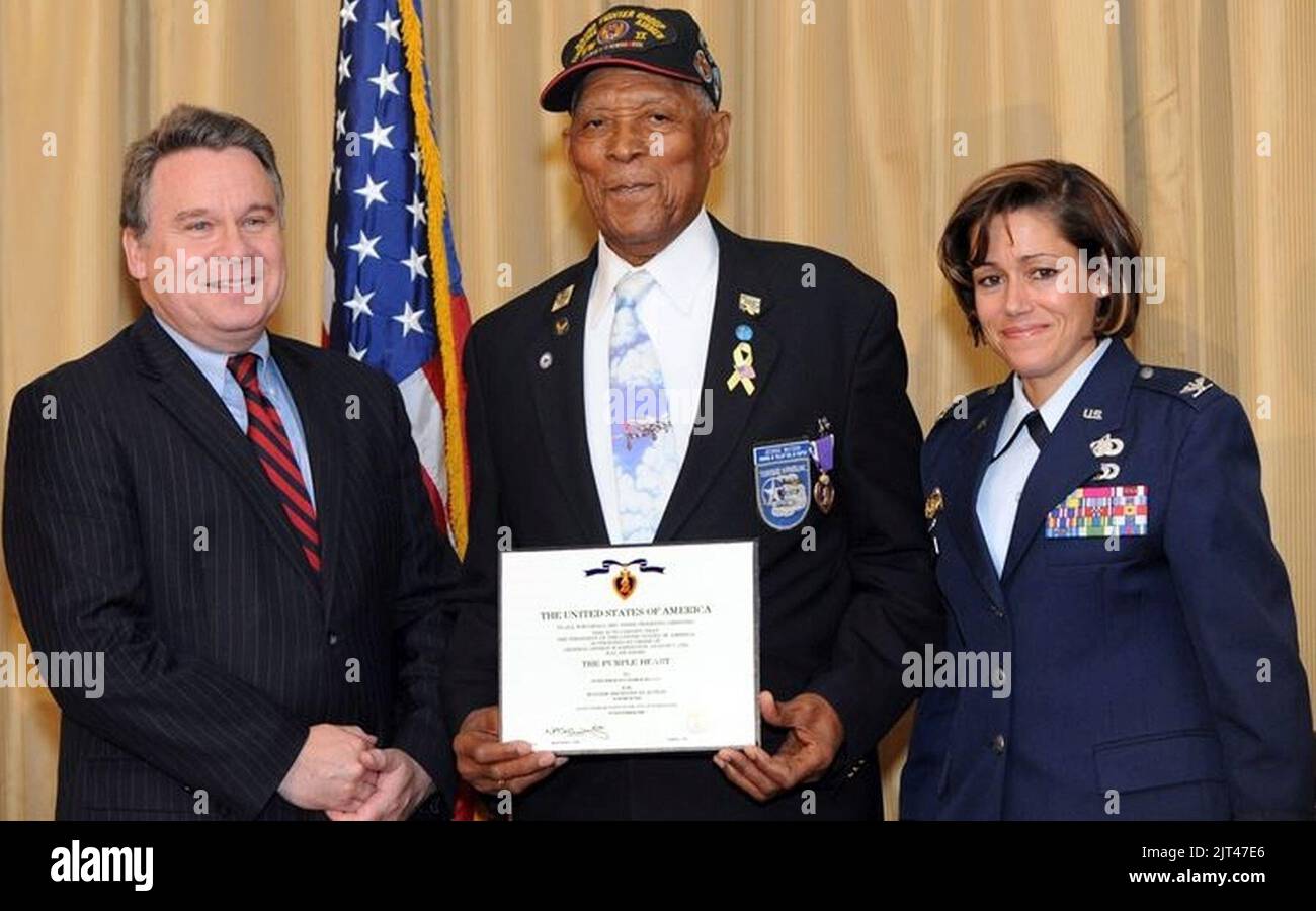 Tuskegee Airman Tech. Sgt. (Ret.) is presented the Purple Heart medal by Congressman Christopher ...