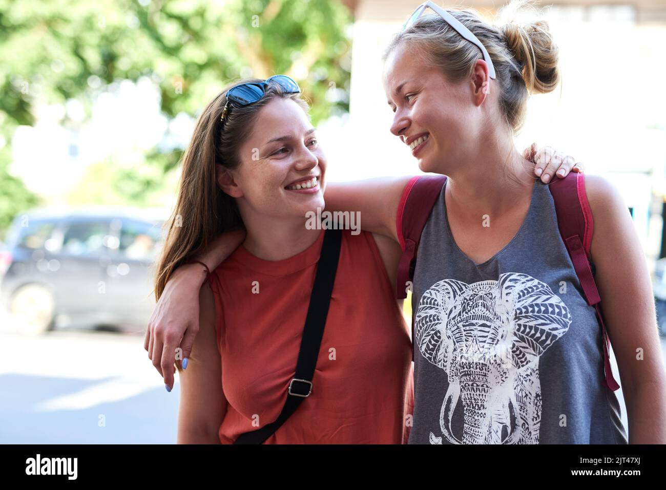 Weekends are for hanging out with friends. two young friends walking ...