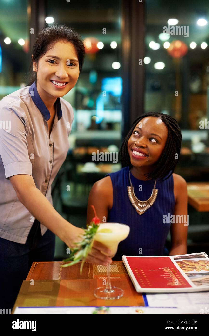 My customers always leave happy. Portrait of a young waitress serving a ...
