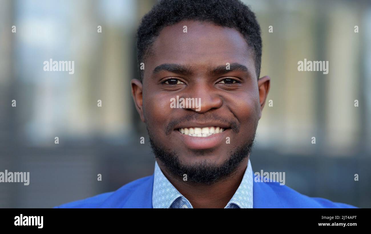 Black businessman enjoys occupation showing toothy smile Stock Photo ...