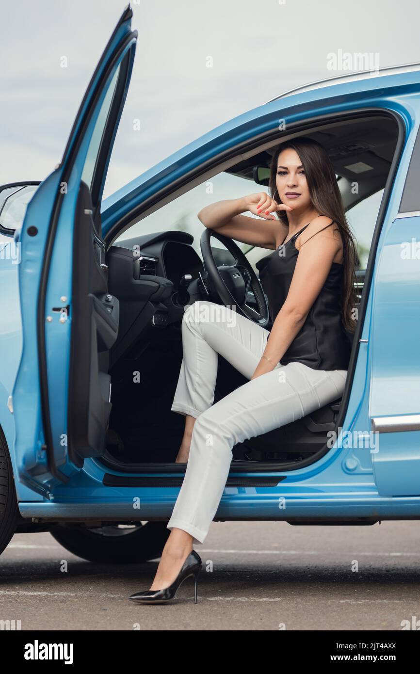 Successful lady driver demonstrates confident pose in car Stock Photo ...
