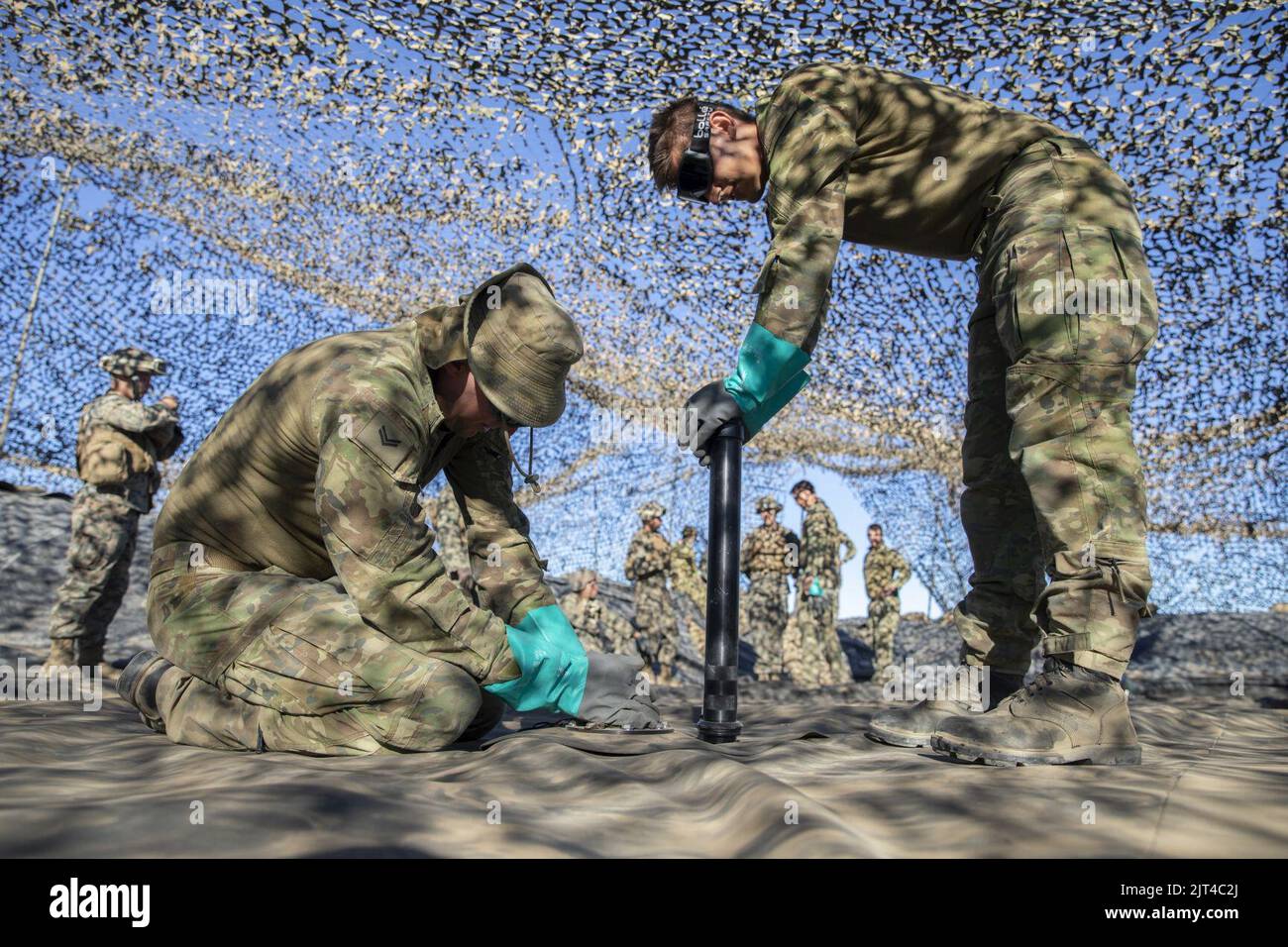Two 10 FSB petroleum operators removing a stem valve during Exercise ...