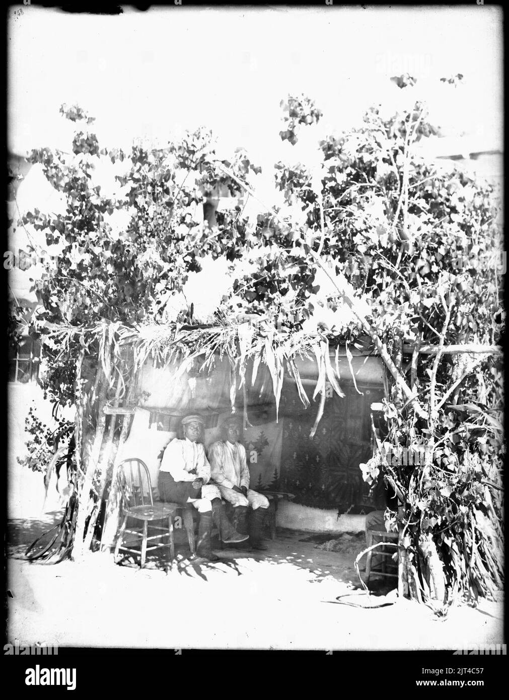 Two Acoma Indian men sitting before the sacred kisi of San Esteban ...