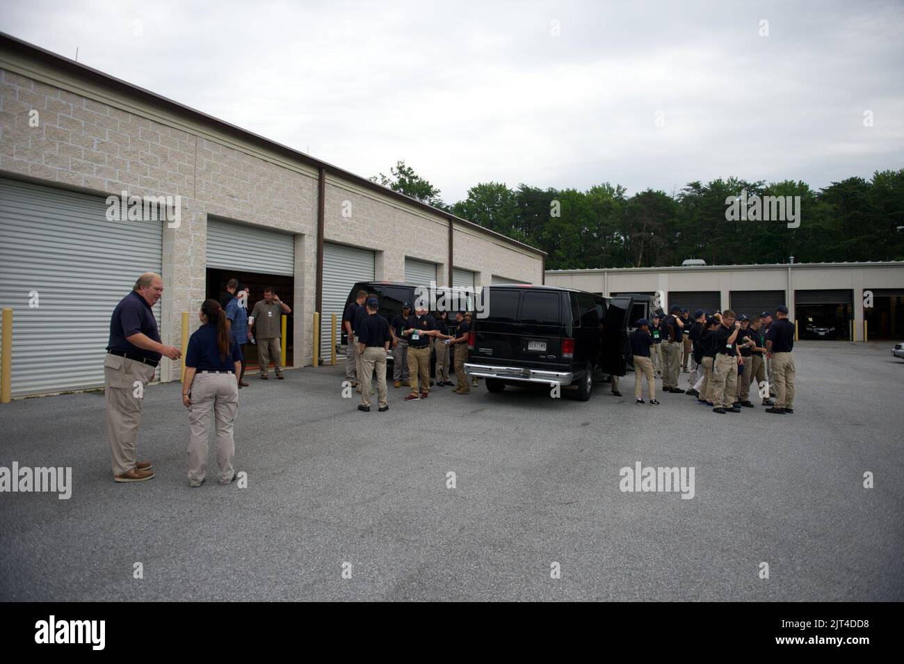 Two groups of law enforcement explorers stand around a vehicle Stock ...