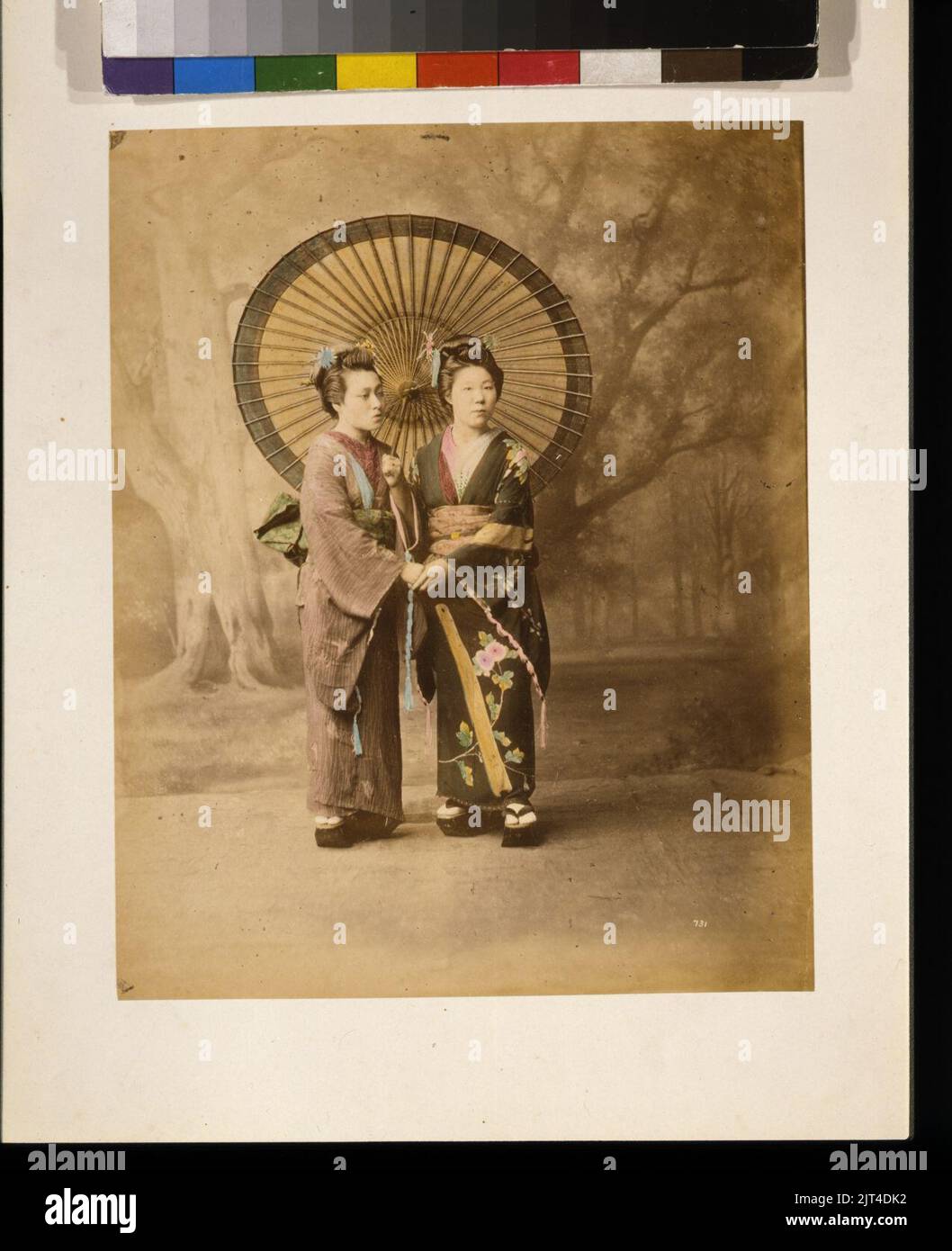 Two Japanese women, full-length studio portrait with backdrop, facing ...