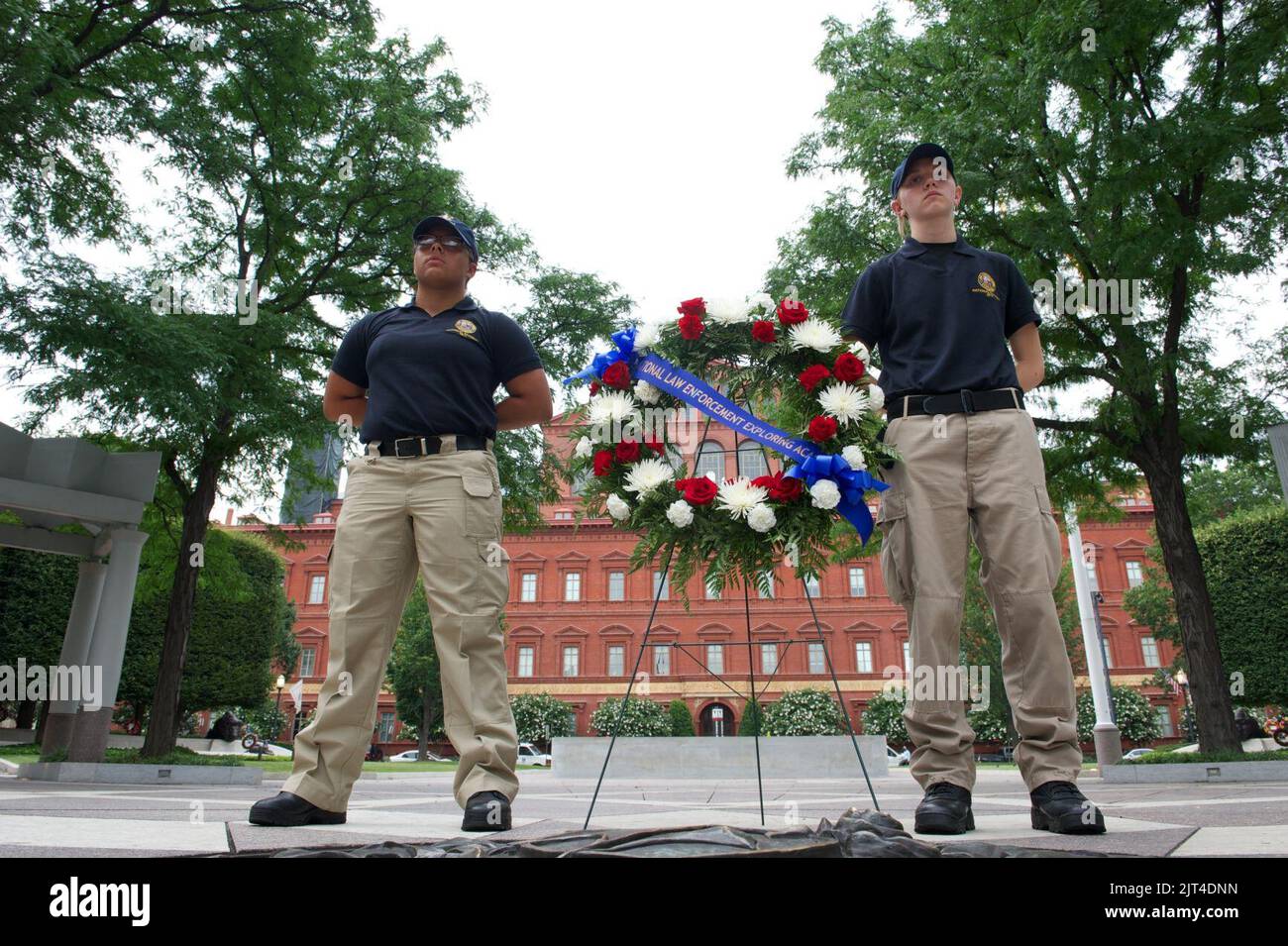 Two law enforcement explorers stand next to a wreath at the National ...