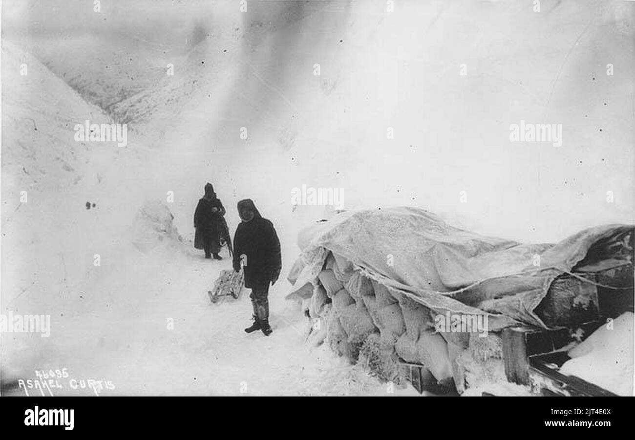 Two men at a cache at the summit of White Pass, Alaska-British Columbia ...