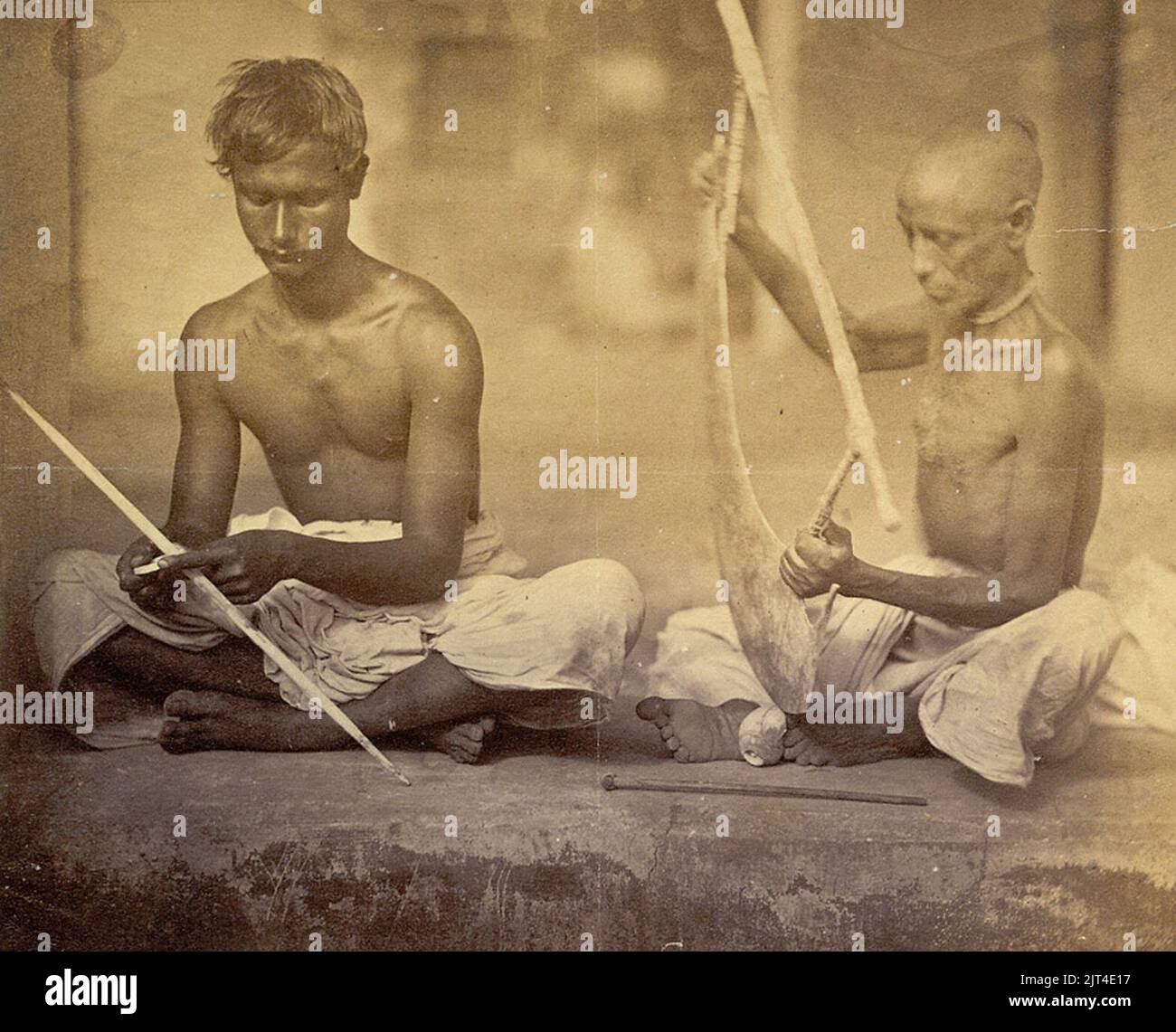 Two men at work cutting and polishing shells for making bracelets for ...