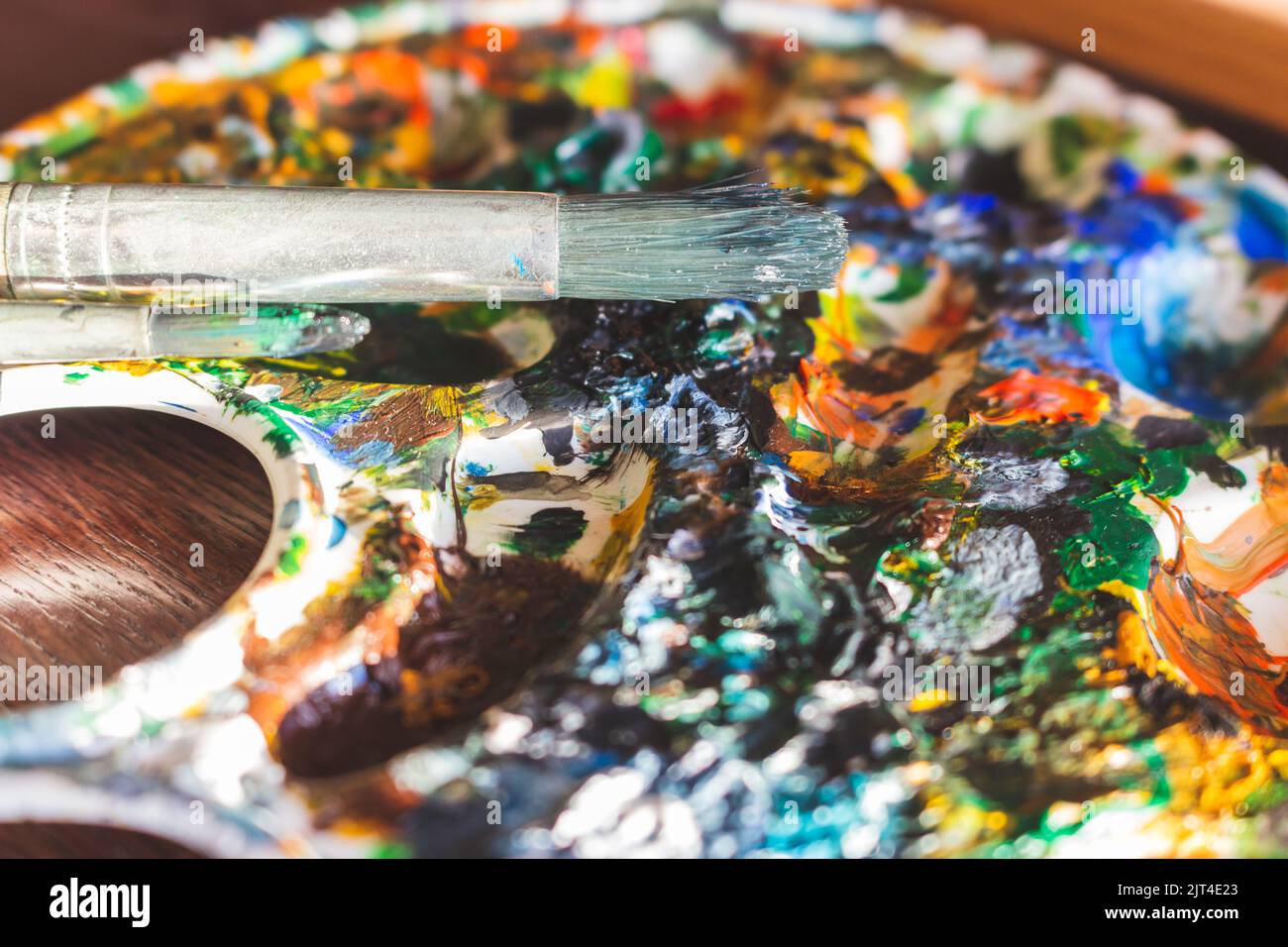 Bright colorful paints with painting brush, close up. Multicolored ...