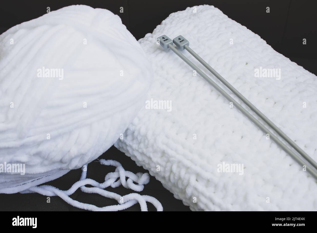 White cotton wool and needles. Soft white handcraft. Cozy winter ...