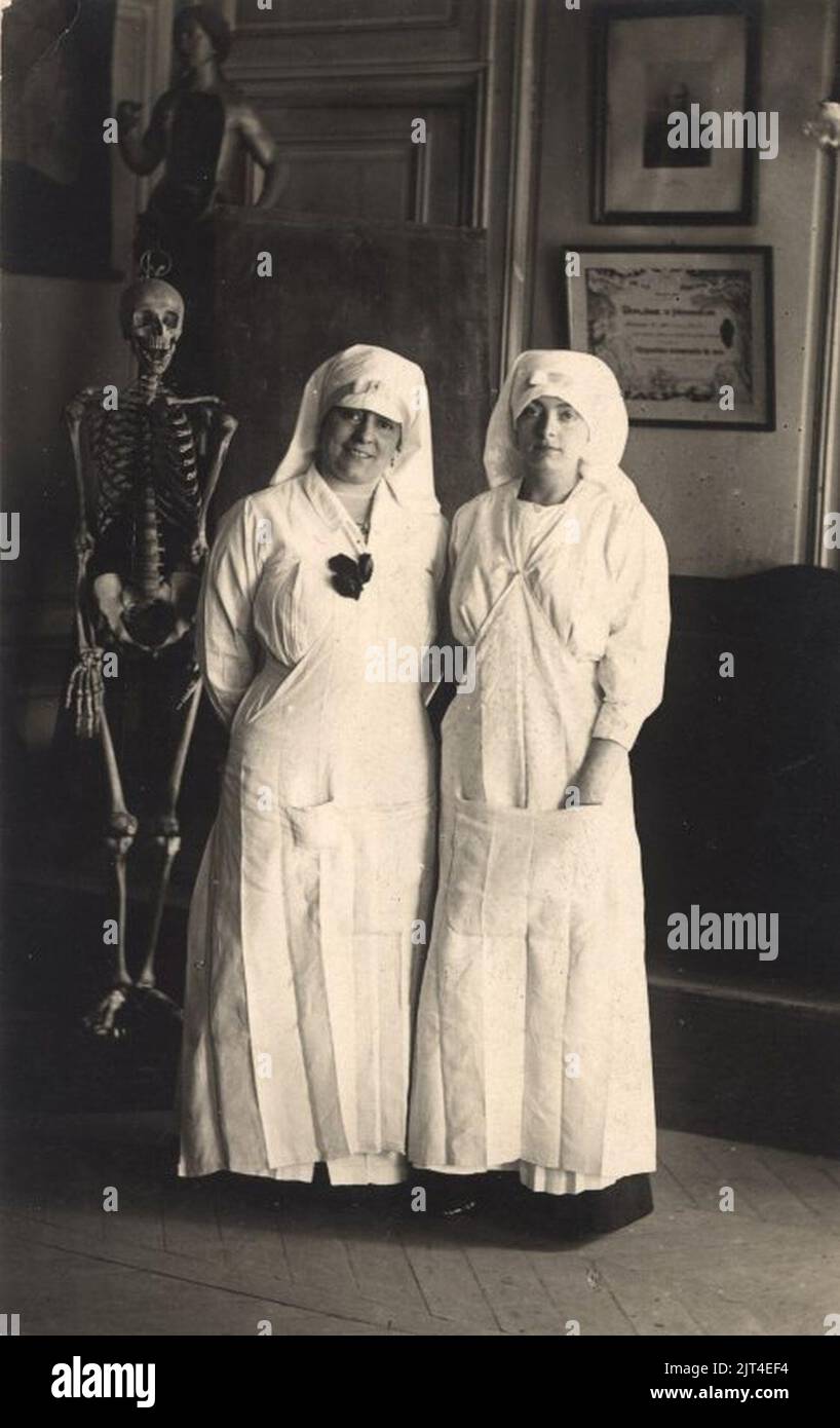 Two nurses pose before a skeleton and female anatomical manikin Stock ...