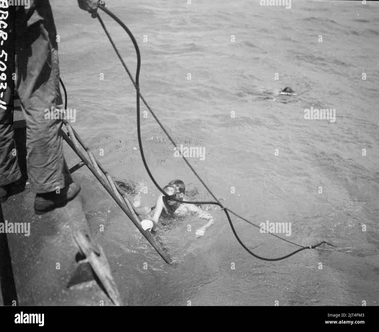 Two surface swimmers directing divers to coral heads, Bikini Atoll ...