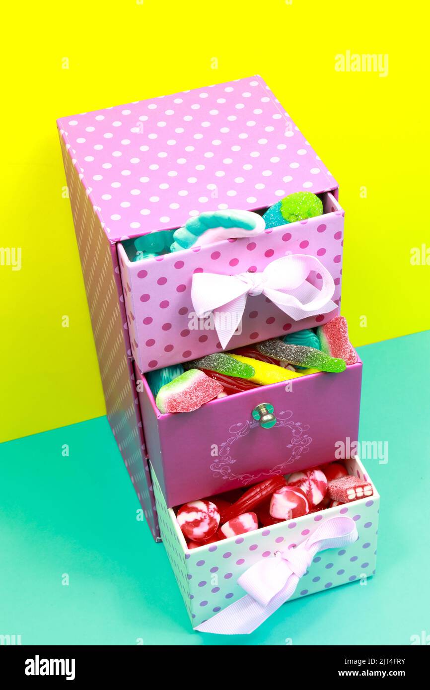 A vertical closeup of a small decorated box with sweets isolated on a ...