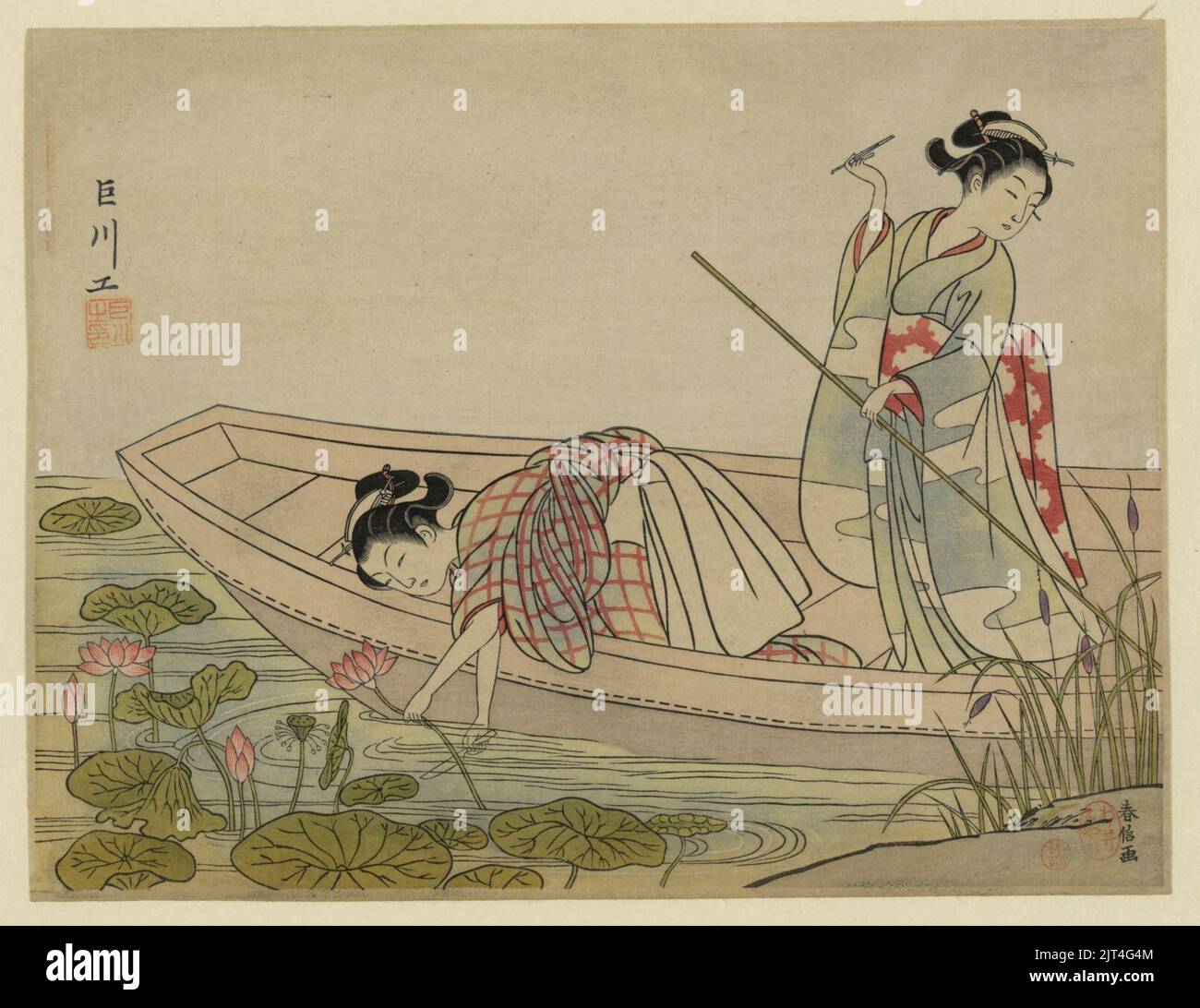 Two women gathering lotus blossoms Stock Photo - Alamy