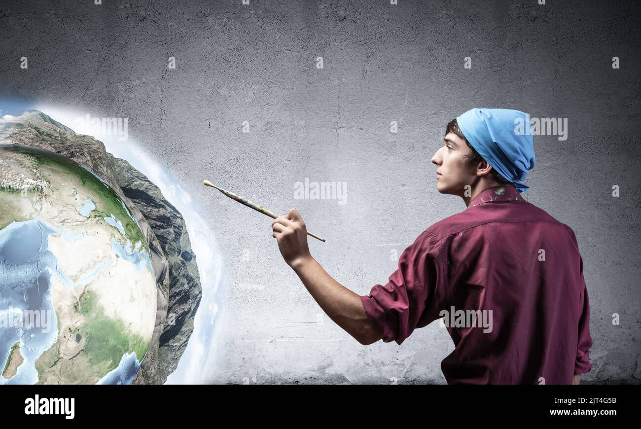 Young artist drawing earth globe Stock Photo - Alamy