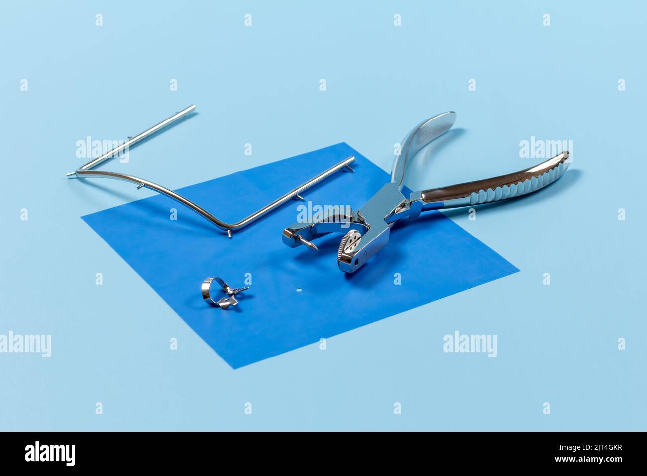 Dental hole punch, the clamp, the metal frame and the rubber dam on the ...