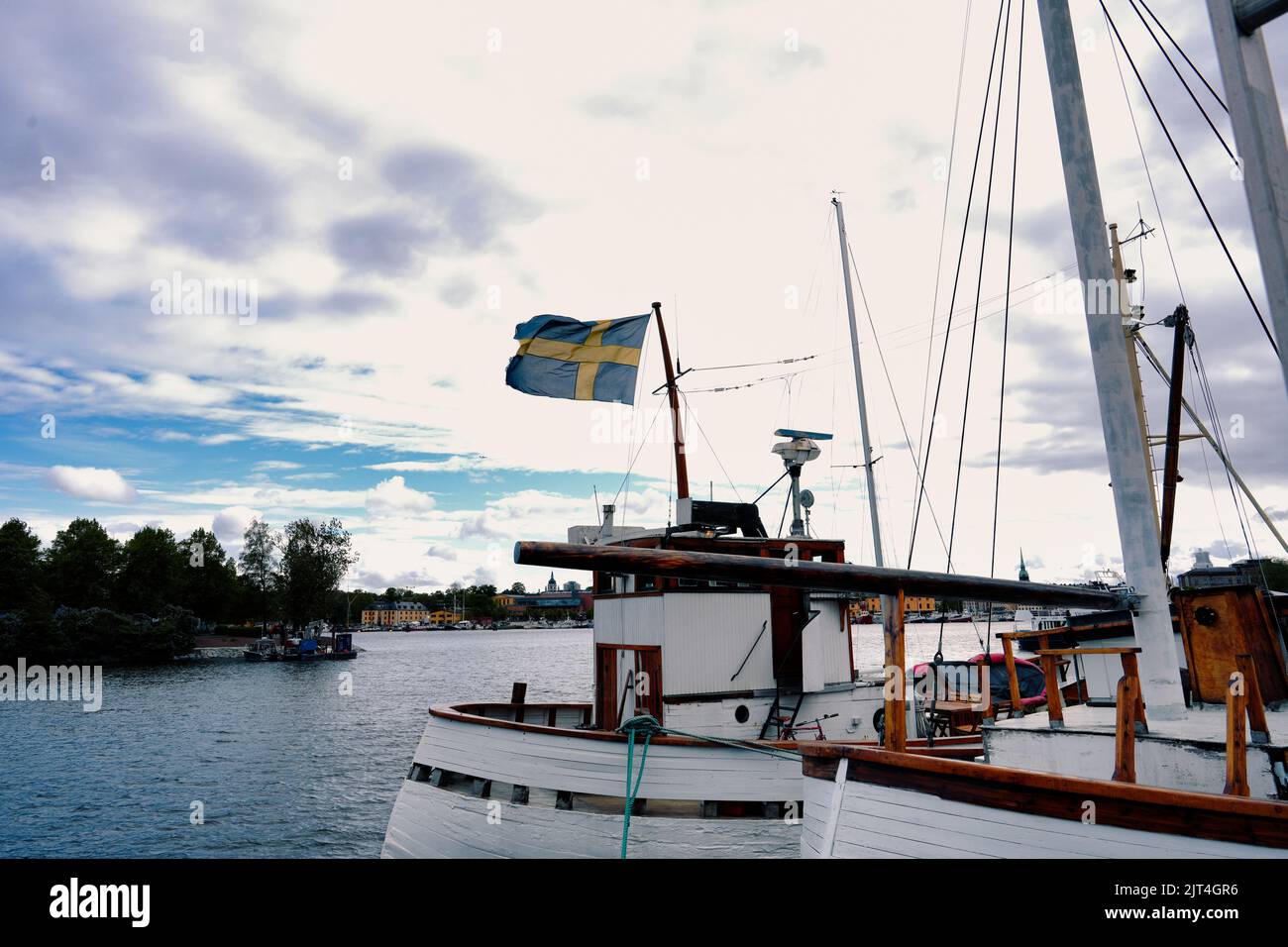 A boat with the Sweden flag moored in a port Stock Photo - Alamy