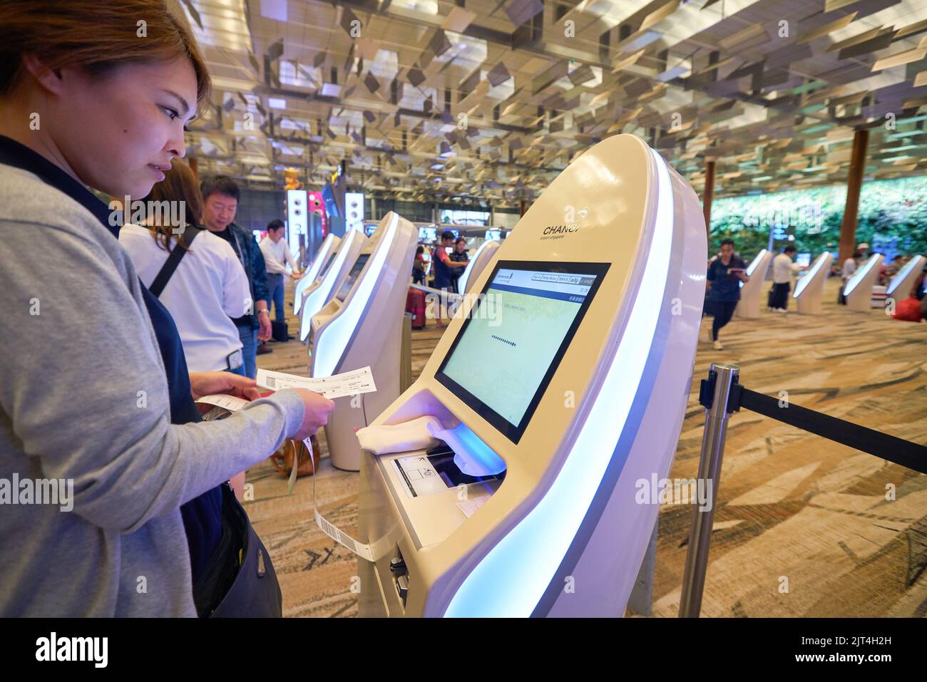 SINGAPORE - CIRCA JANUARY, 2020: a traveller at the self check-in kiosk at Terminal 3, Singapore ...