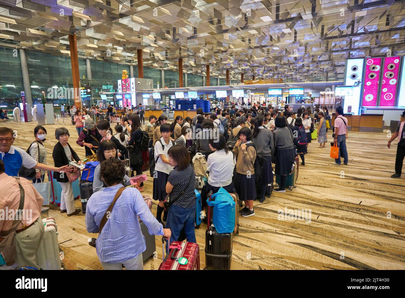 SINGAPORE - CIRCA JANUARY, 2020: people stand in line waiting for check ...