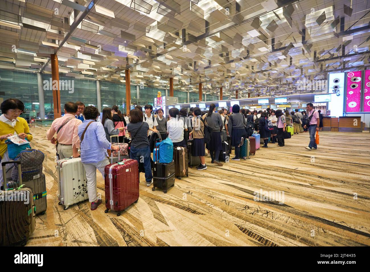 SINGAPORE - CIRCA JANUARY, 2020: people stand in line waiting for check ...