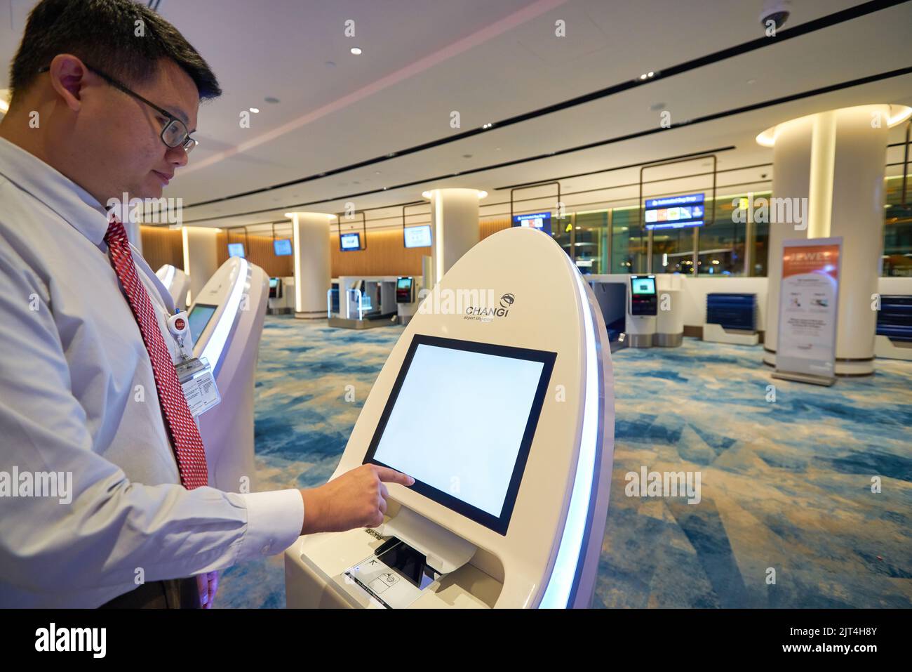 SINGAPORE - CIRCA JANUARY, 2020: staff help traveller at the Early ...
