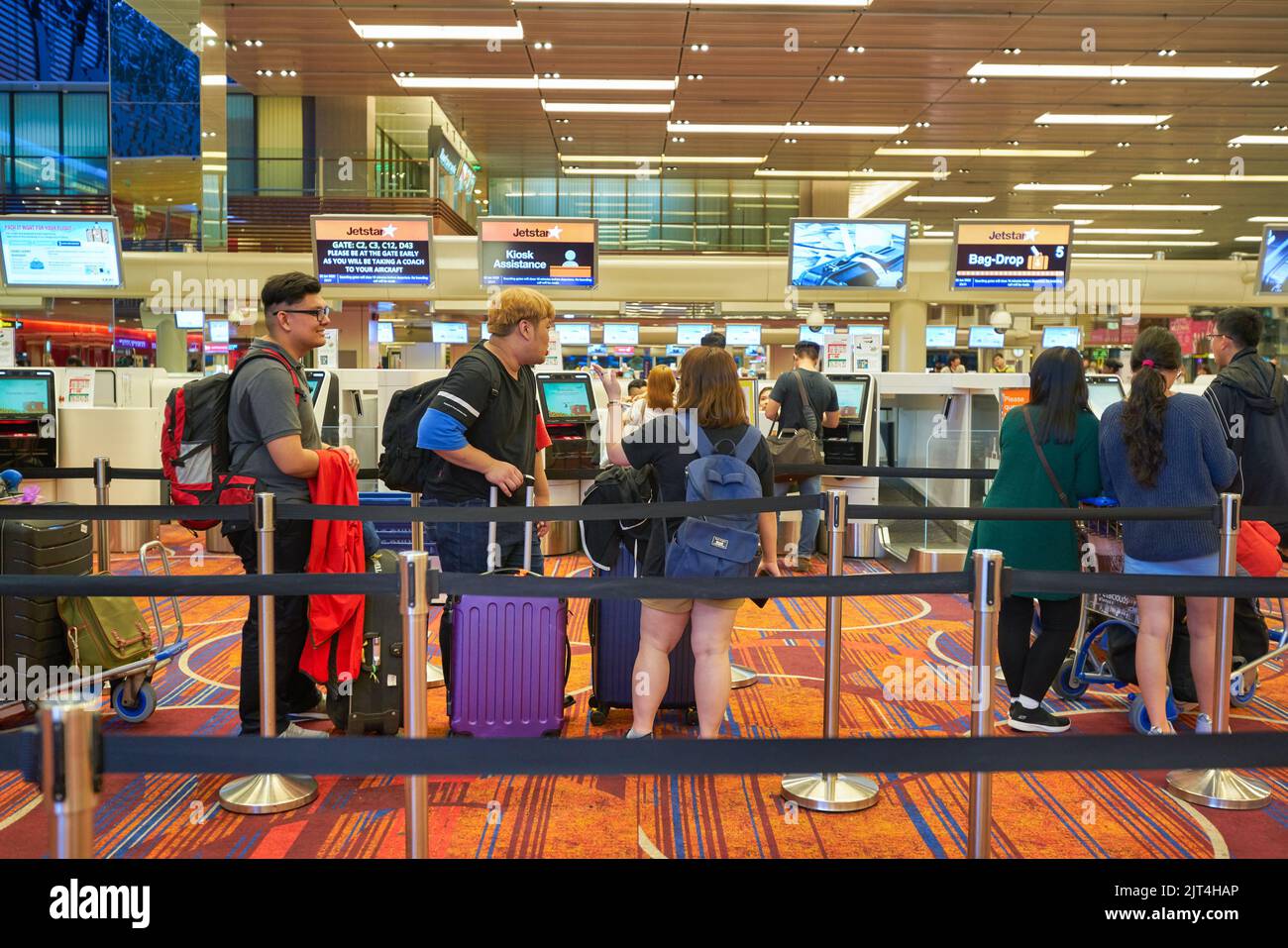SINGAPORE - CIRCA JANUARY, 2020: people stand in line waiting for check ...