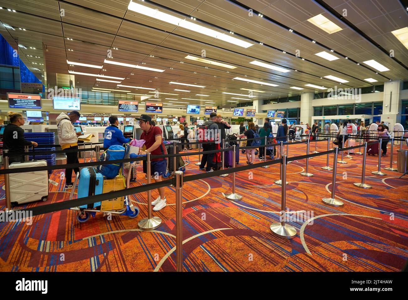 SINGAPORE - CIRCA JANUARY, 2020: people stand in line waiting for check ...